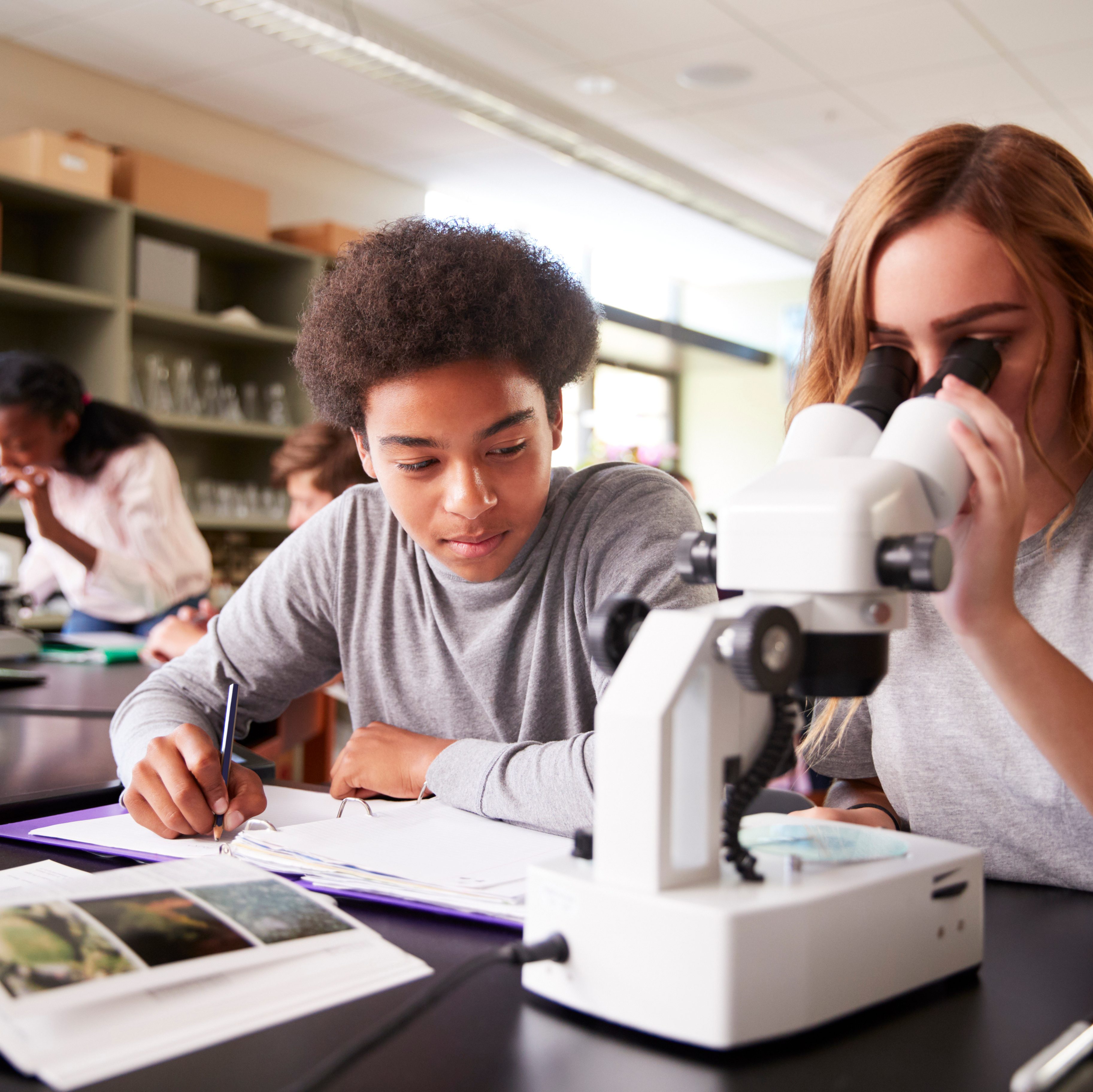 High School Students Looking Through Microscope In Biology Class – The Peak